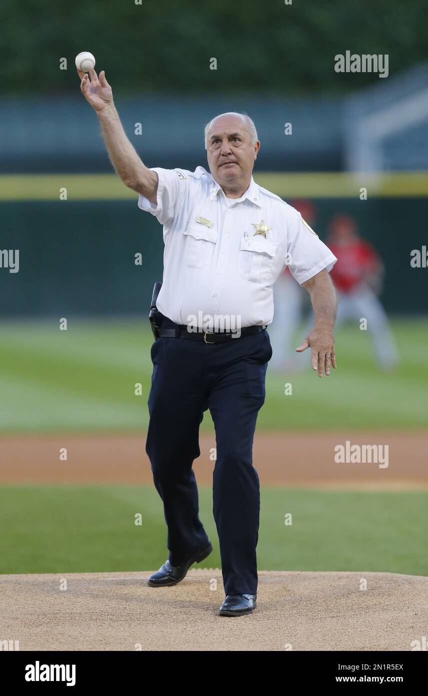Chicago Police Captain Edward Kulbida throws out a ceremonial first ...