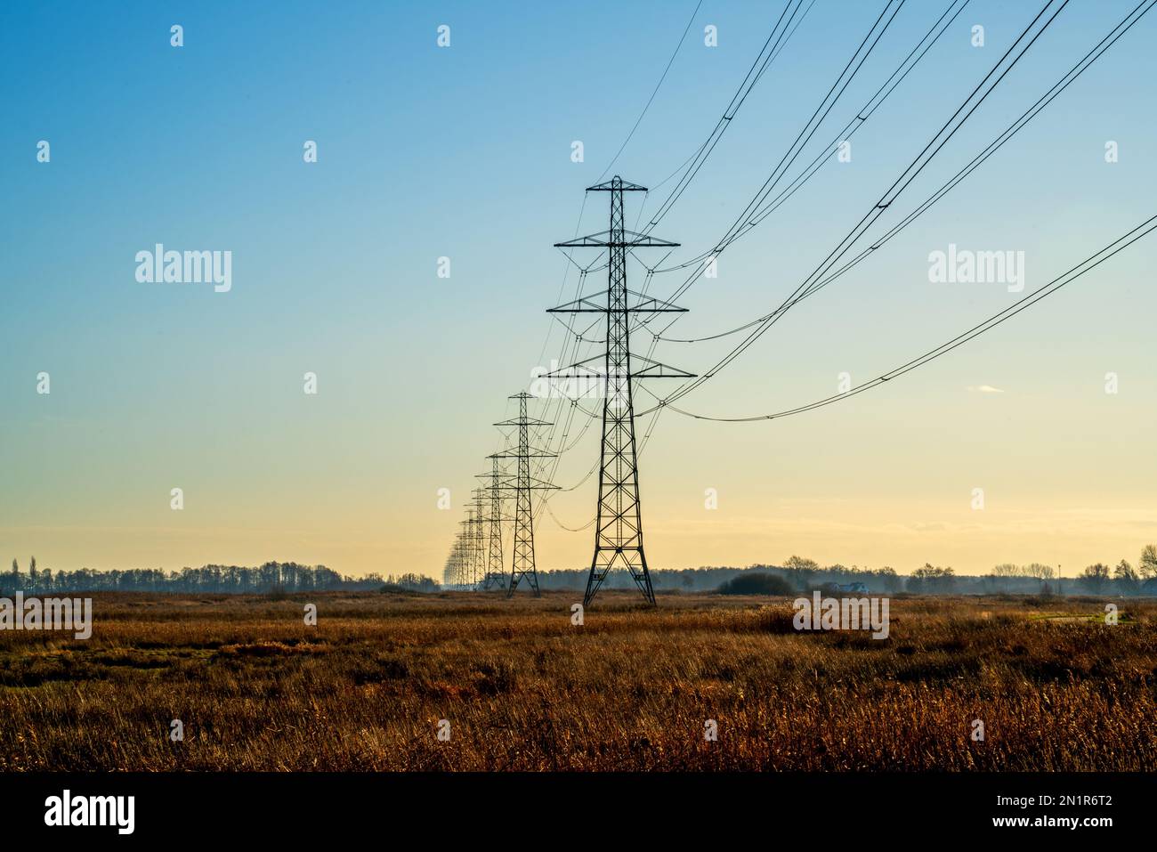 Winter landscape with row of power pylons Stock Photo - Alamy