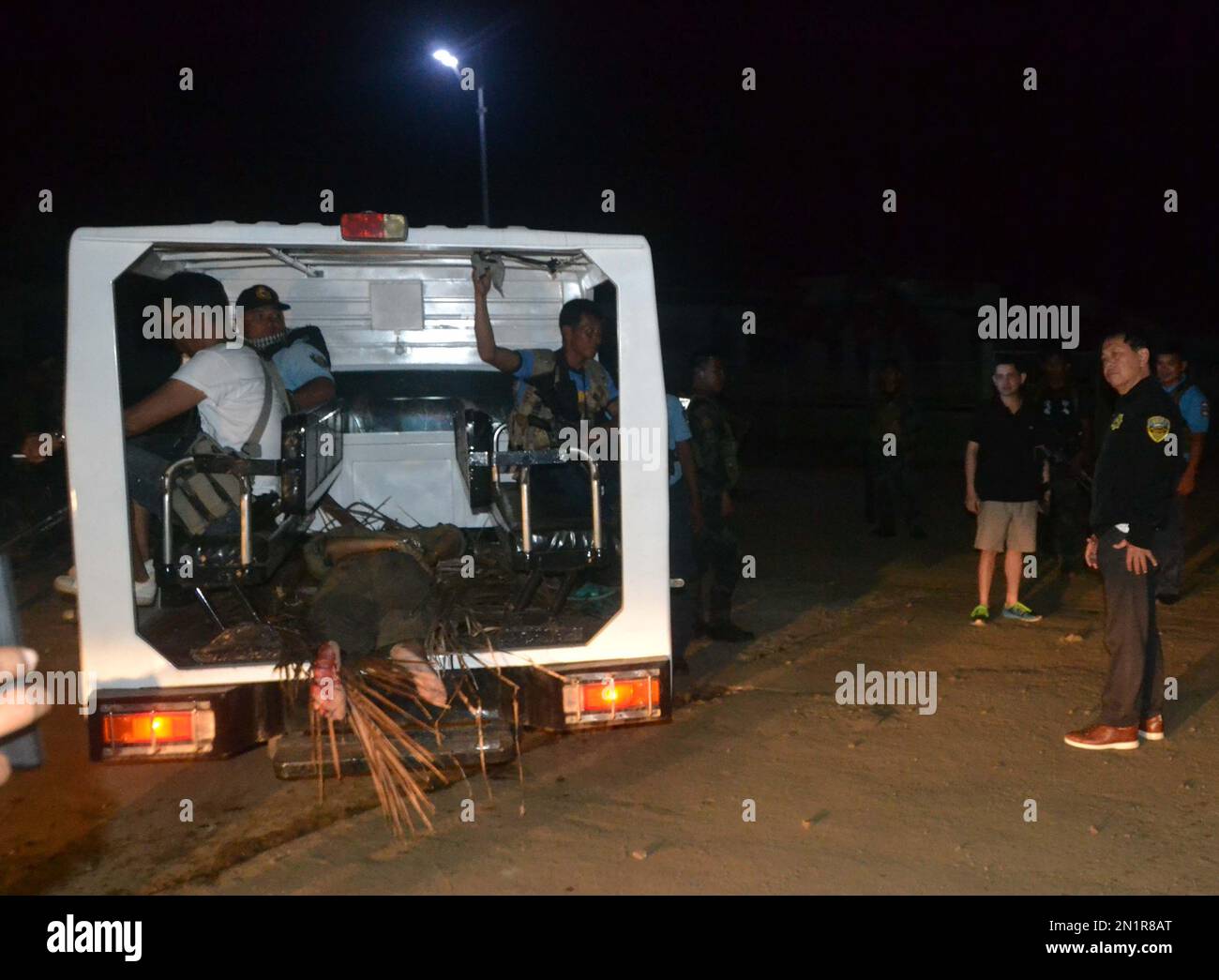 In this Aug. 11 photo, police retrieve the decapitated body of Filipino ...