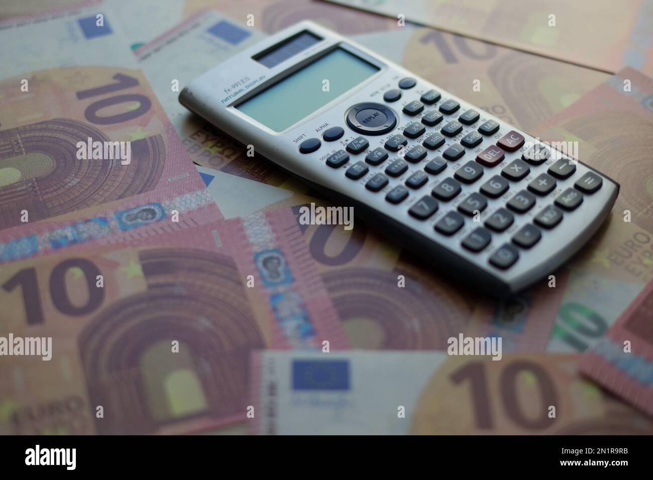 calculator lies on 10 euro banknotes Stock Photo - Alamy
