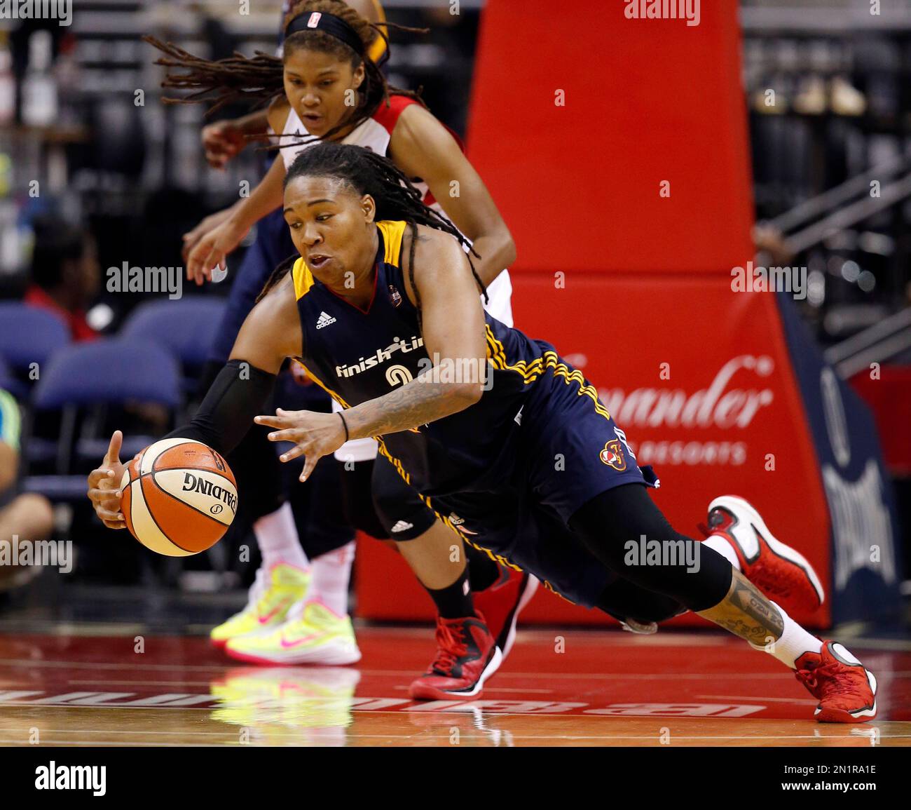 Indiana Fever forward Erlana Larkins, front, dives for the ball in ...