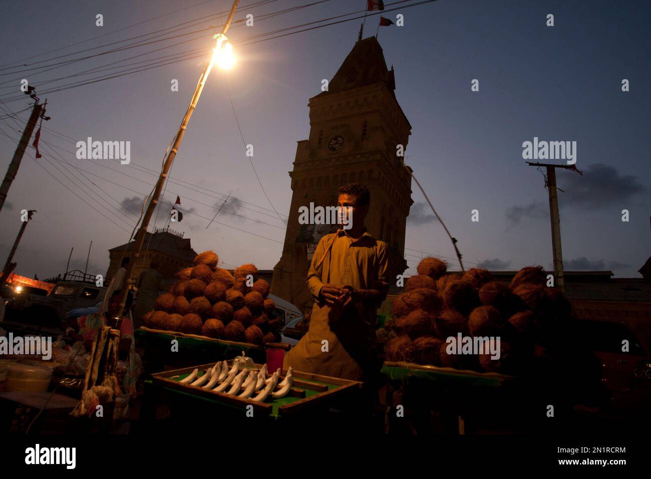 A Pakistani vendor waits for customers at a market in Karachi, Pakistan ...