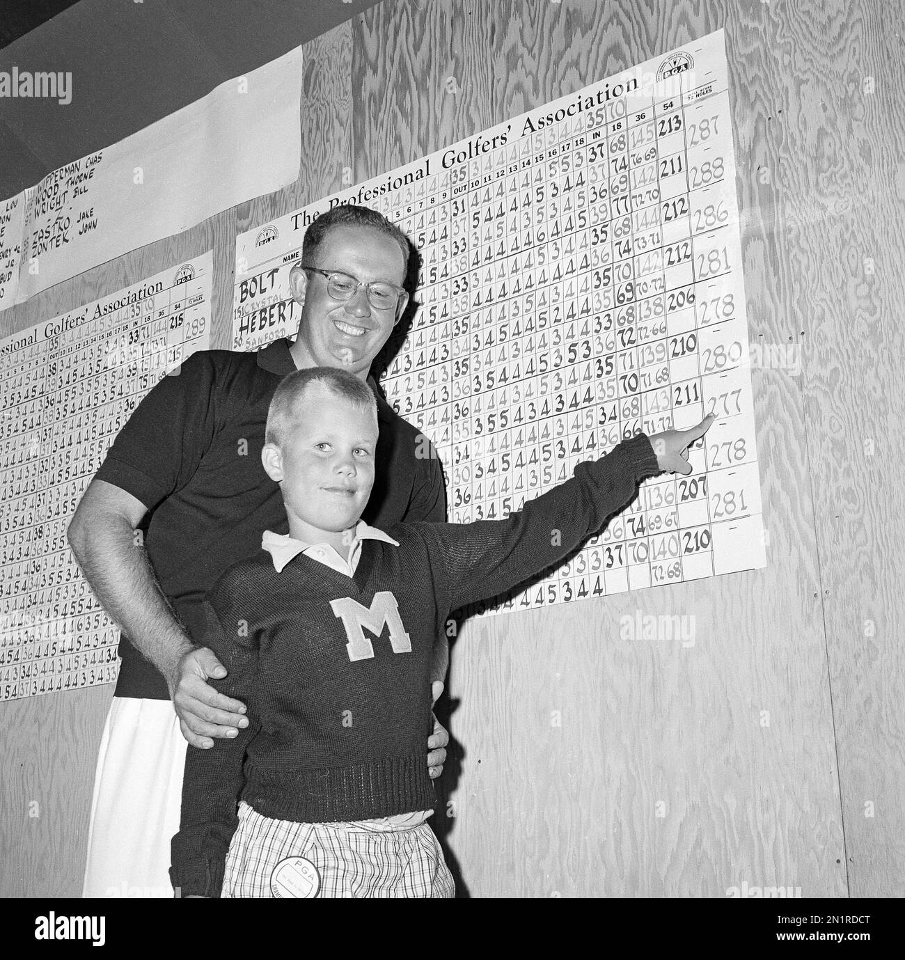 New PGA champion Bob Rosburg shows off his son, Bob Jr., in front of ...