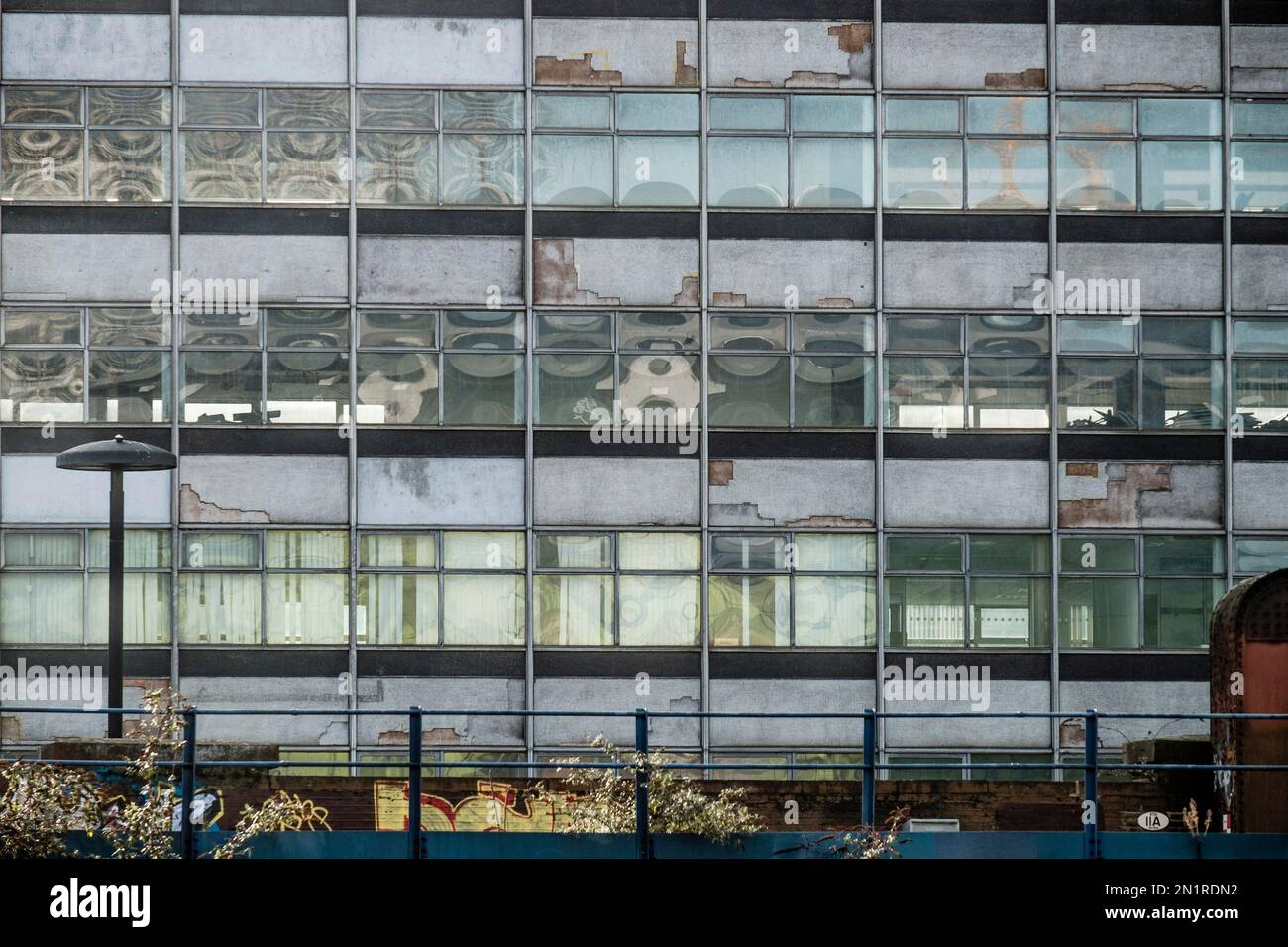 The crumbling facade of the Tower Building,1960s offices adjacent to ...