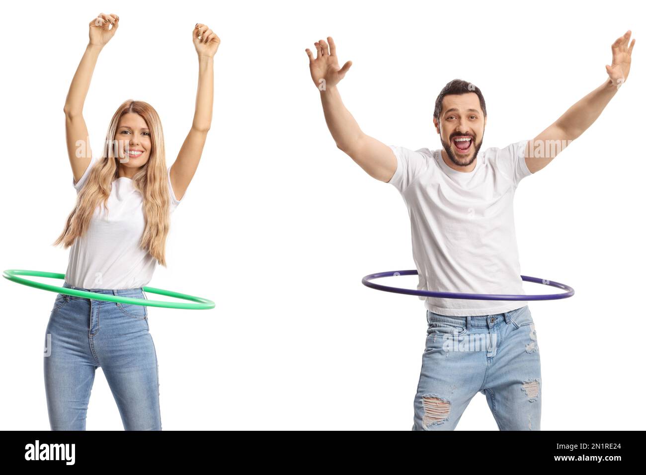 Cheerful young man and woman spinning hula hoops isolated on white ...