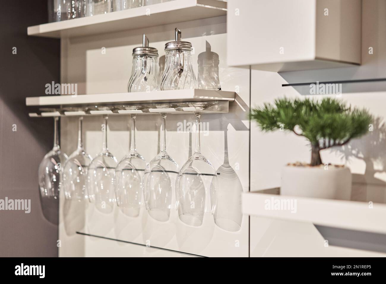 Glasses, dishes and bowls in a cabinet in a kitchen. Kitchen storage ...