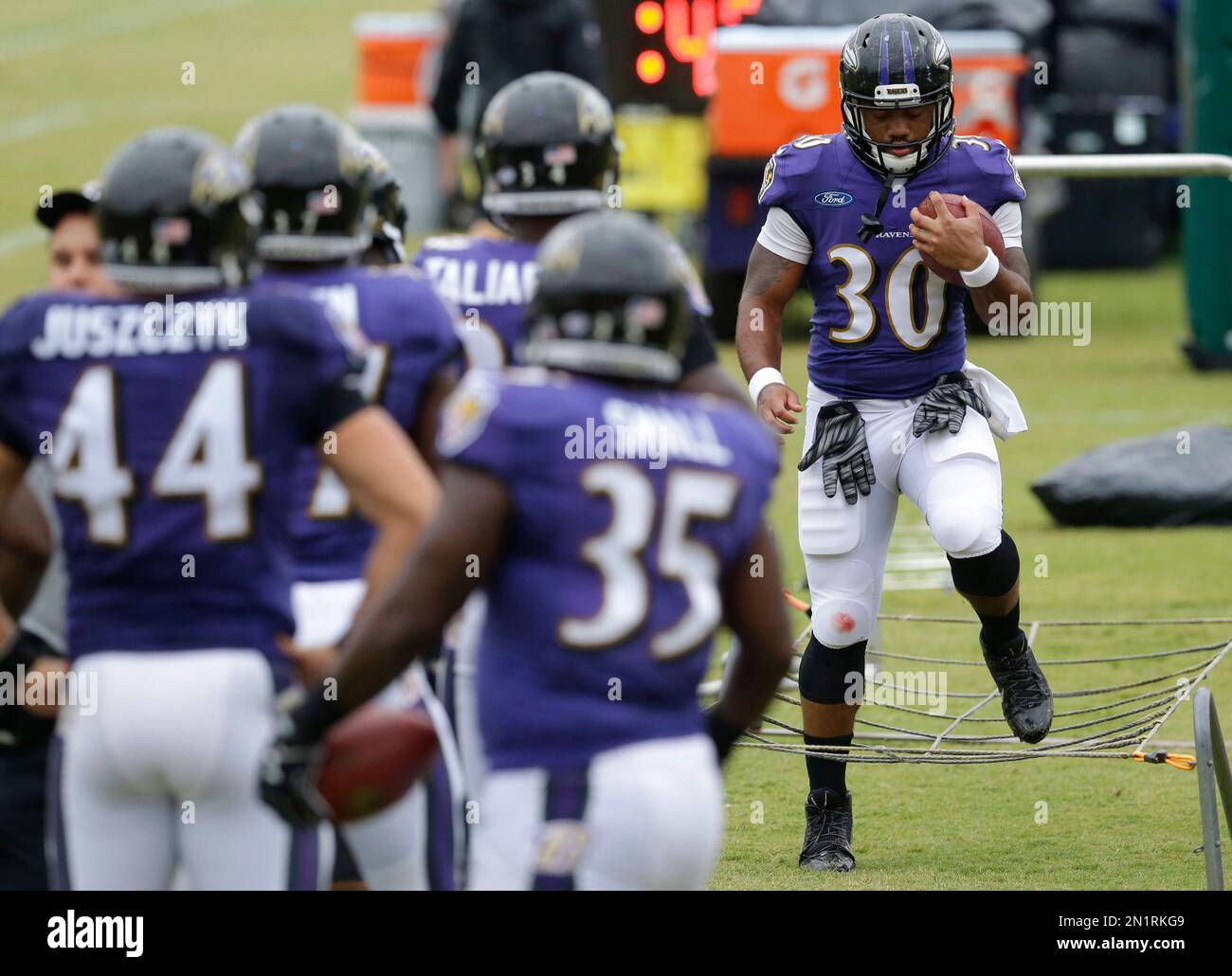 Baltimore Ravens running back Terrence Magee (30) runs a drill in front ...