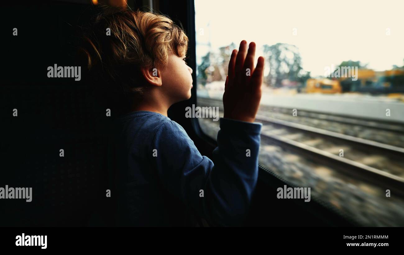 Dreamy clip of a Child leaning on train window looking at landscape ...