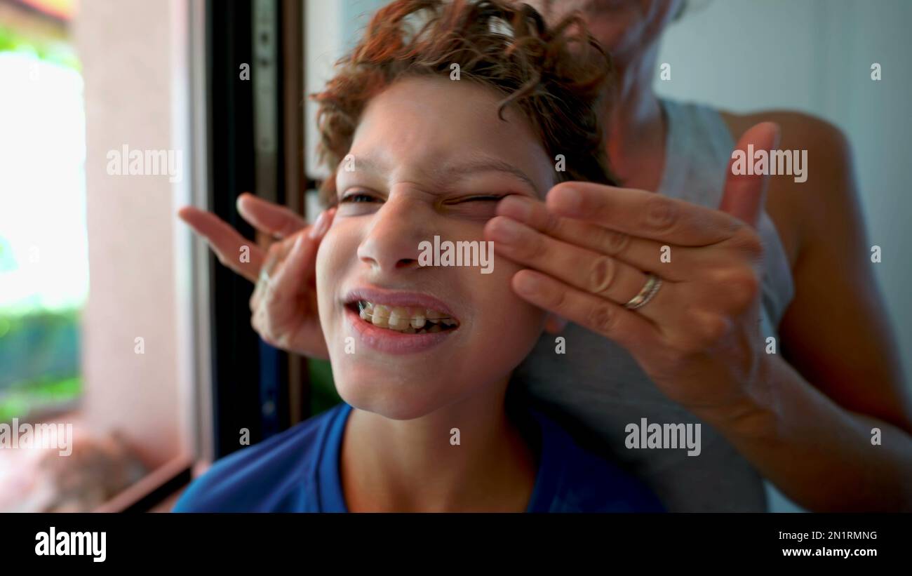 Closeup parent hands applying sunscreen lotion to child face closeup ...
