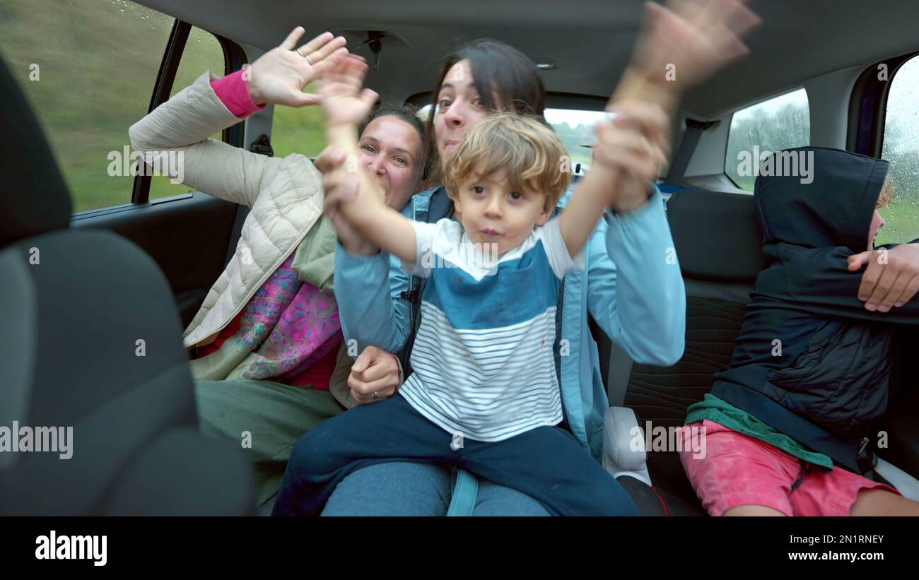 Happy family in car backseat traveling on road. Kids and women travel ...