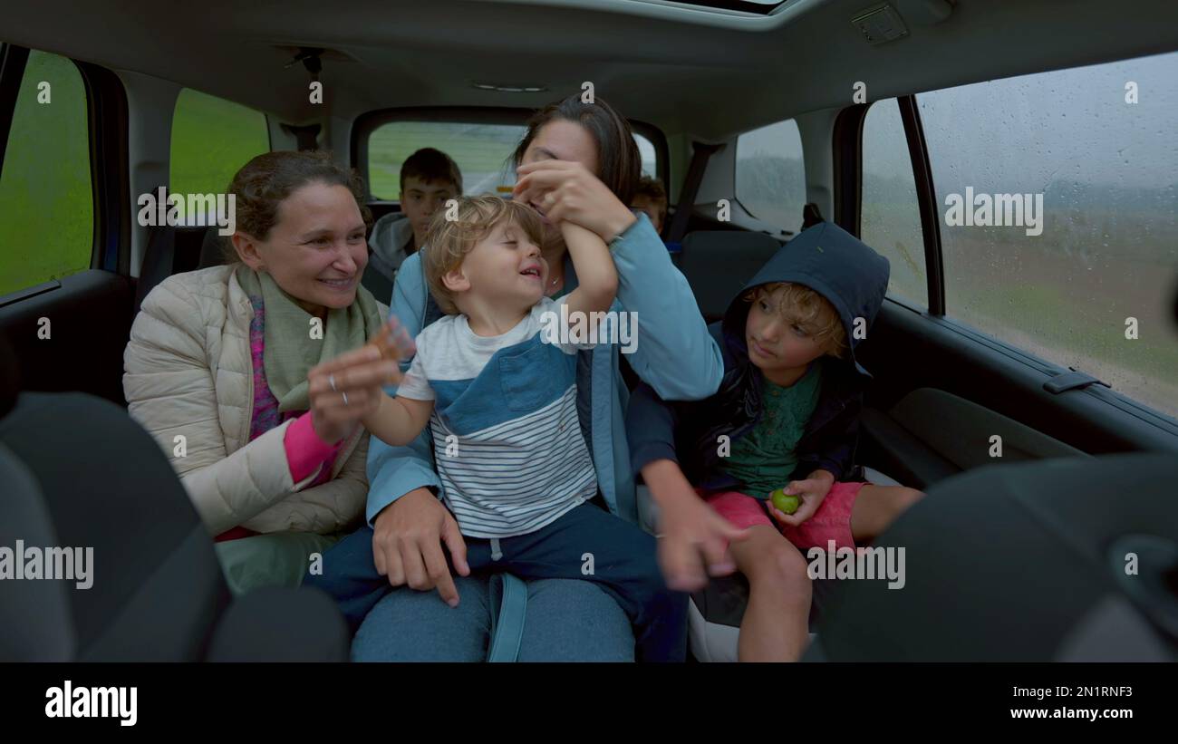 Happy people inside car backseat waving hands laughing and smiling ...