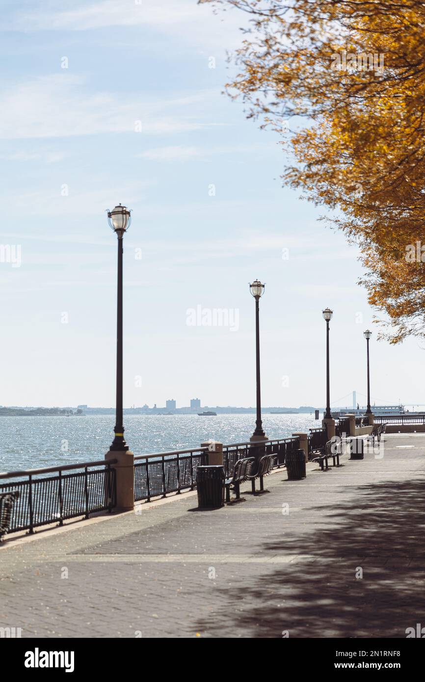 embankment with lanterns and walkway near river bay in New York City ...