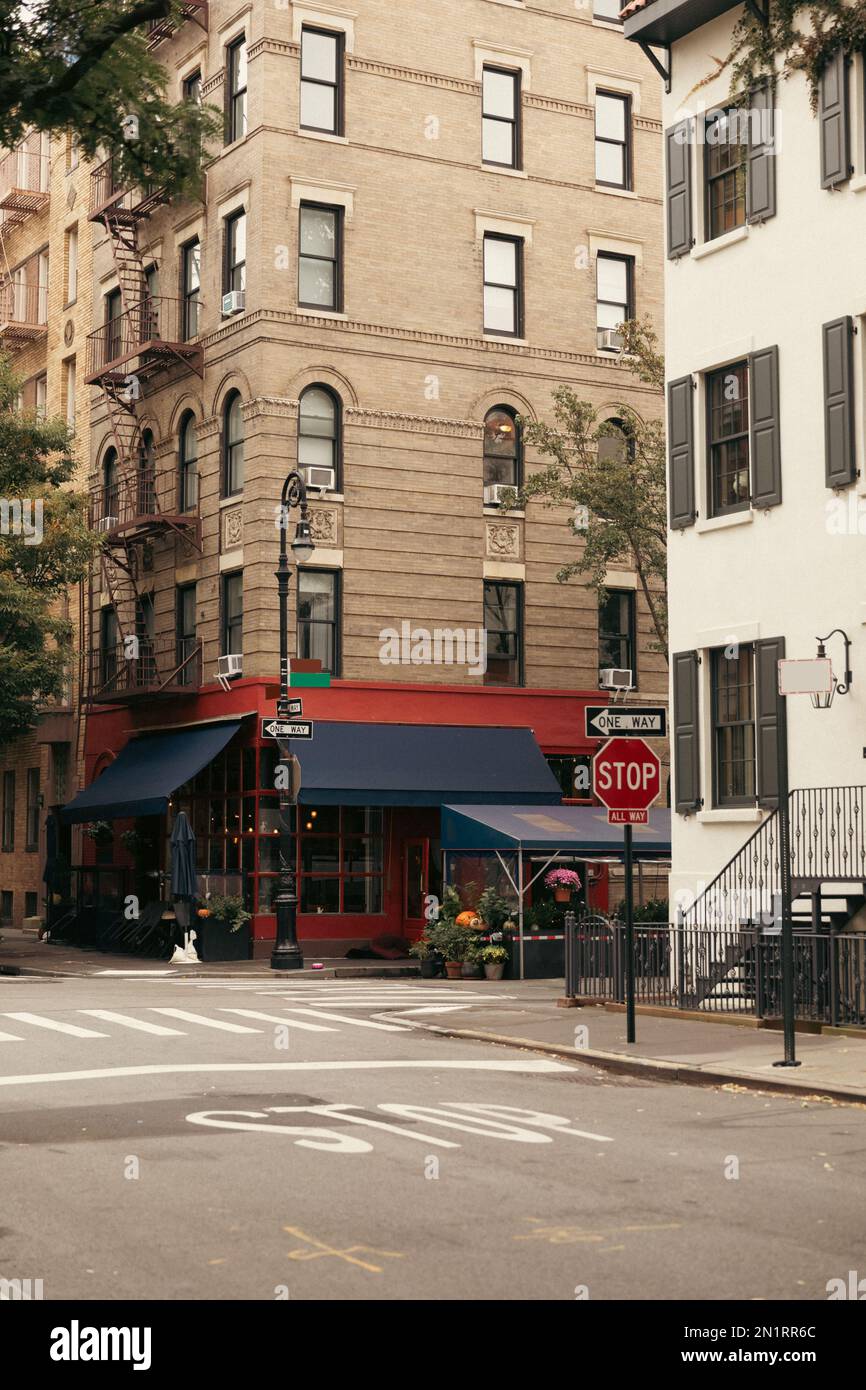building with cafe near crosswalk and road signs on urban street in New ...