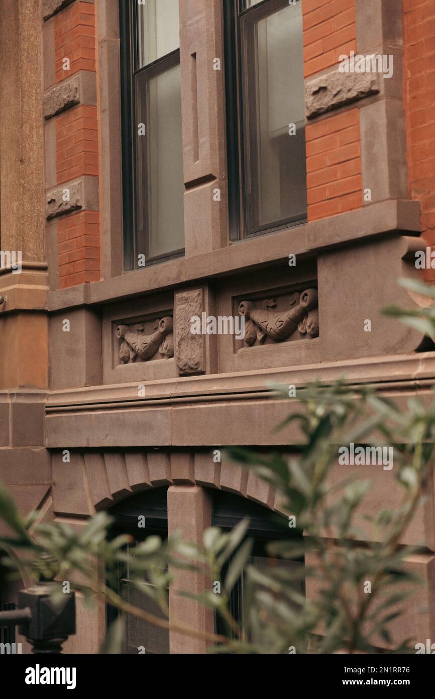 brick building with grey stone decor on urban street of Brooklyn ...