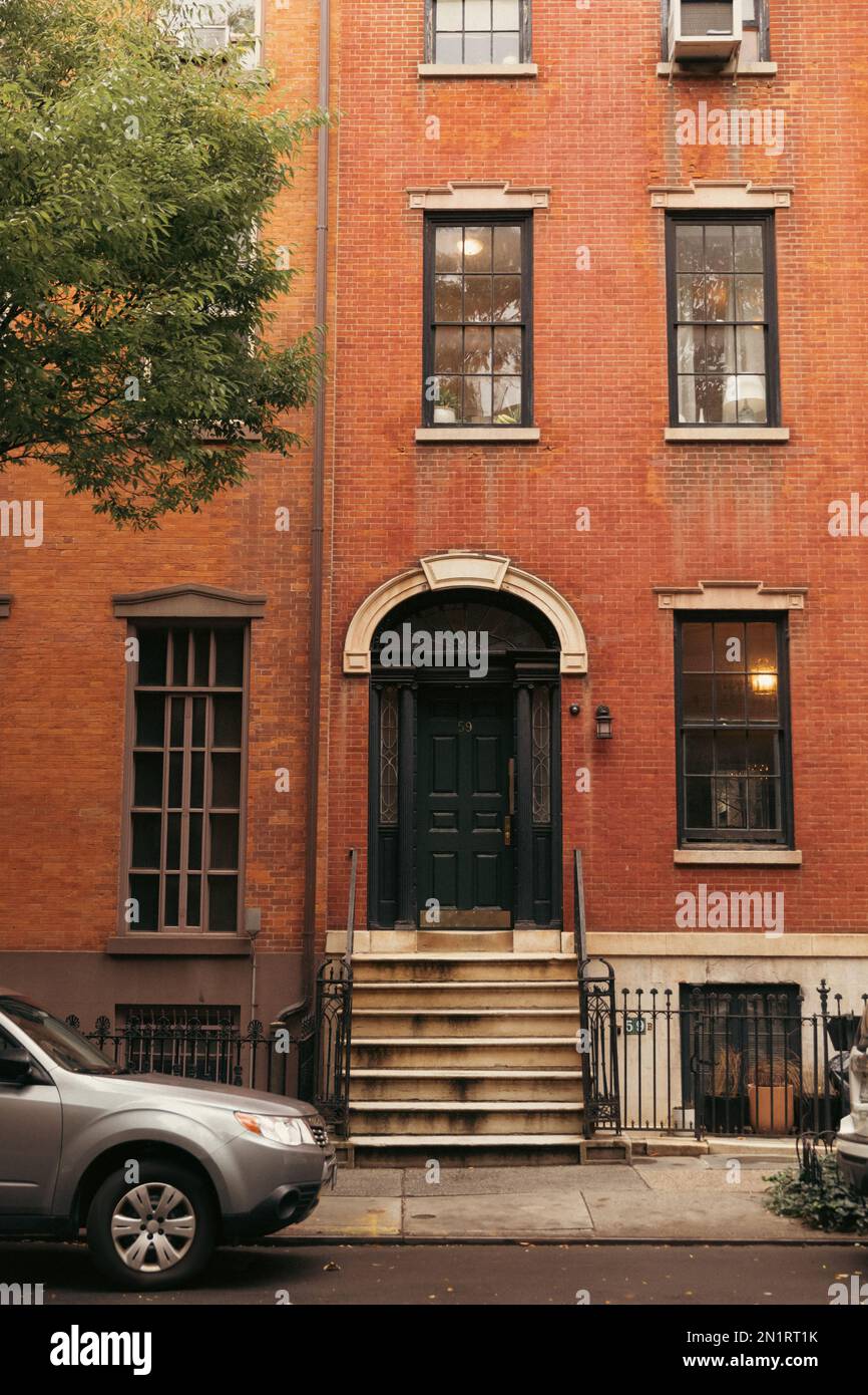 Car near entrance of brick house on street of brooklyn heights in New ...