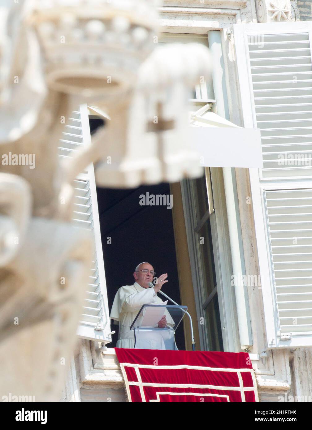 Pope Francis delivers his blessing to the faithful during the Angelus ...