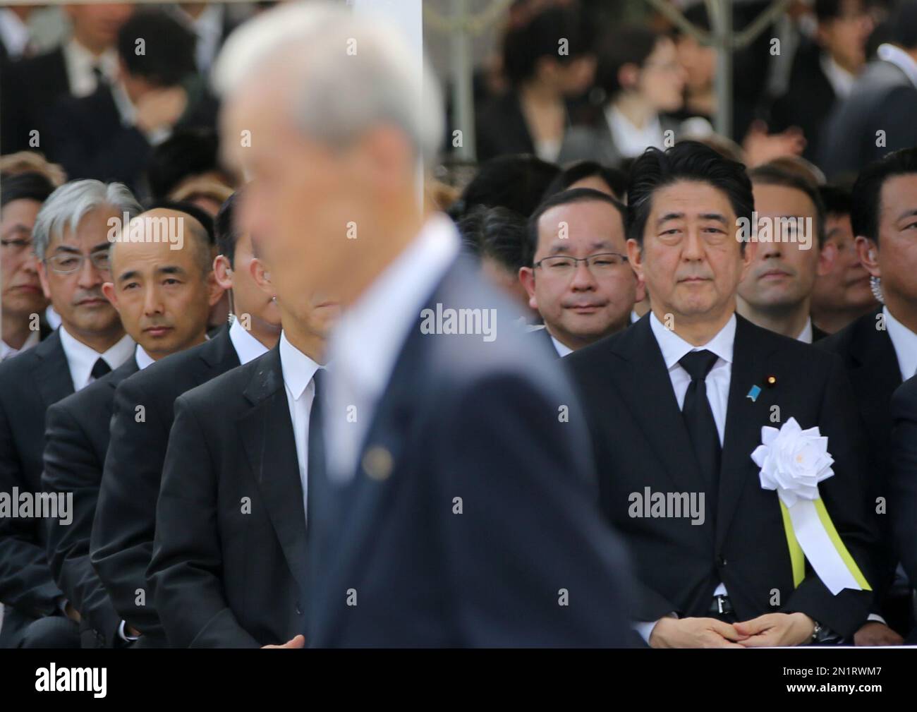 Japanese Prime Minister Shinzo Abe, right, looks at Sumiteru Taniguchi ...