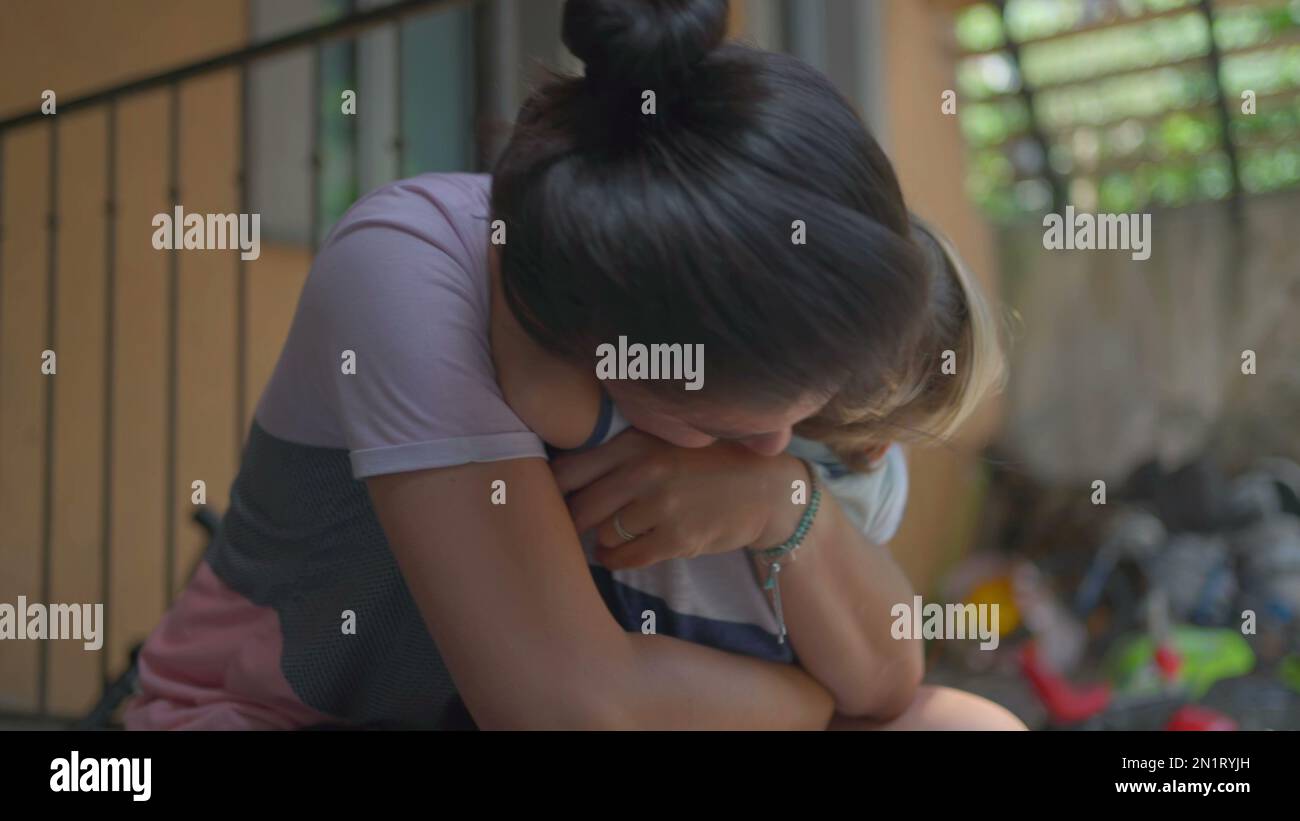 Child hugging mother consoling. Sad mom being comforted by son. Little boy embraces mom ...