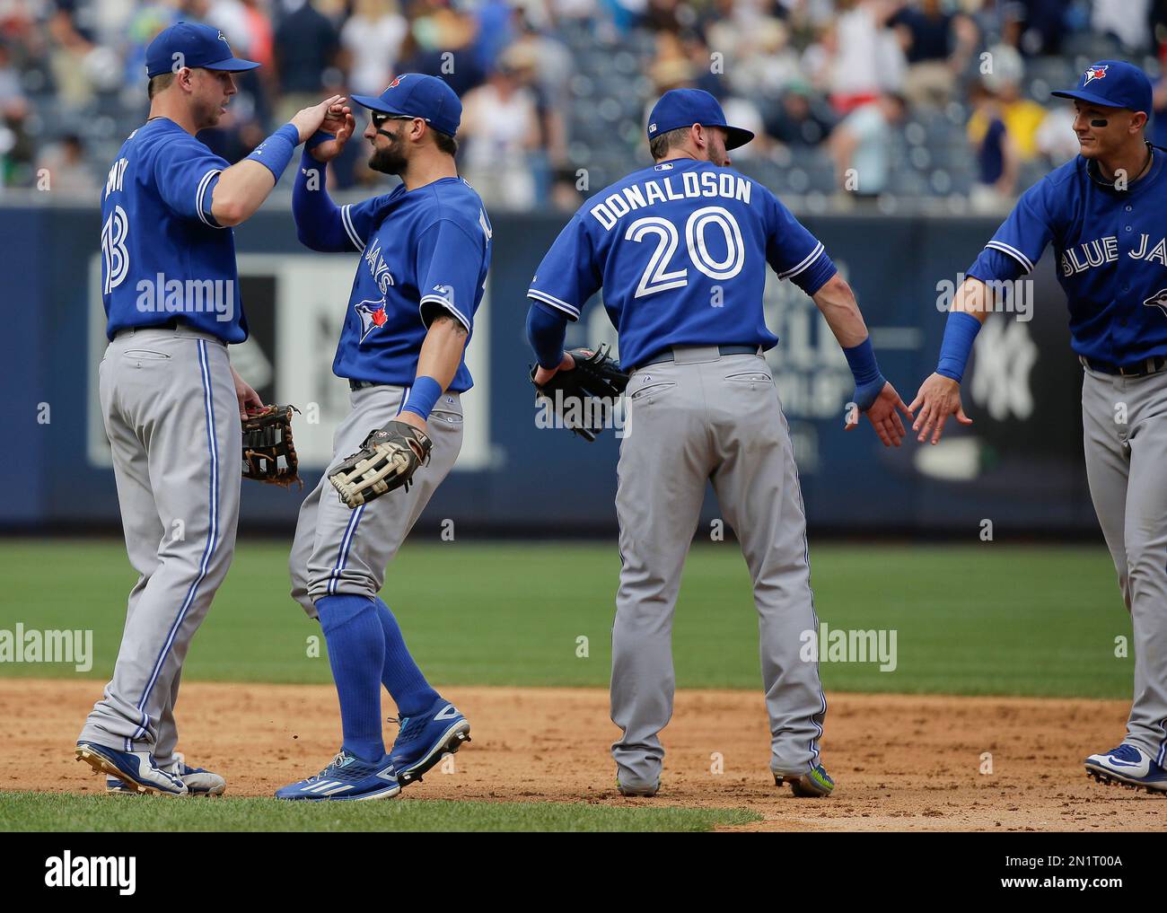 Toronto Blue Jays first baseman Justin Smoak, left, high-fives Kevin ...