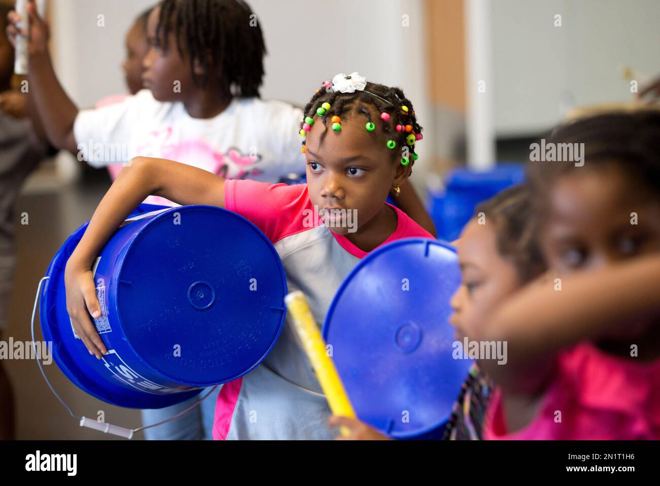 In this, Wednesday, July 29, 2015 photo, Isis Severe, 7, center, learns ...