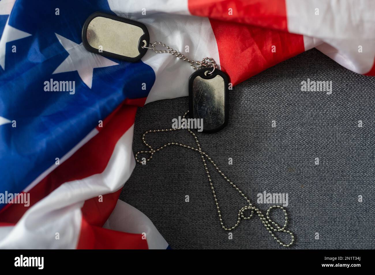 Army tokens on American national flag background Stock Photo - Alamy