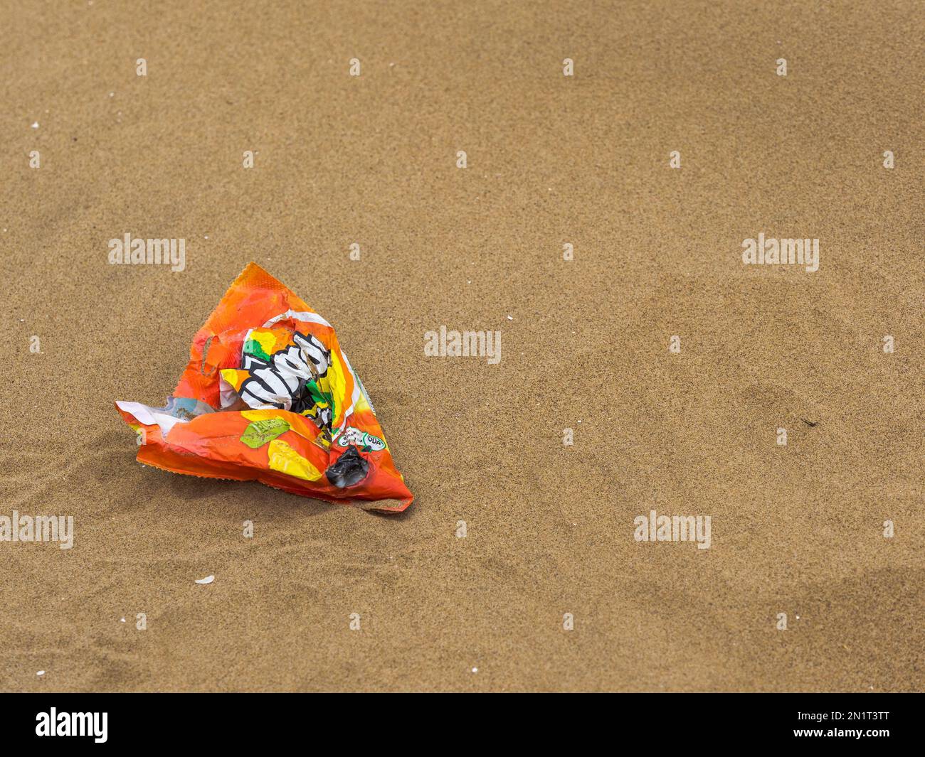 Candy sweet wrappers discarded on the beach copy space for text Stock ...