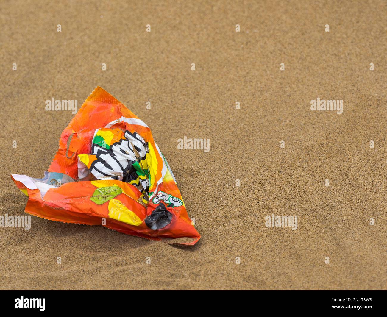 Candy sweet wrappers discarded on the beach copy space for text Stock ...