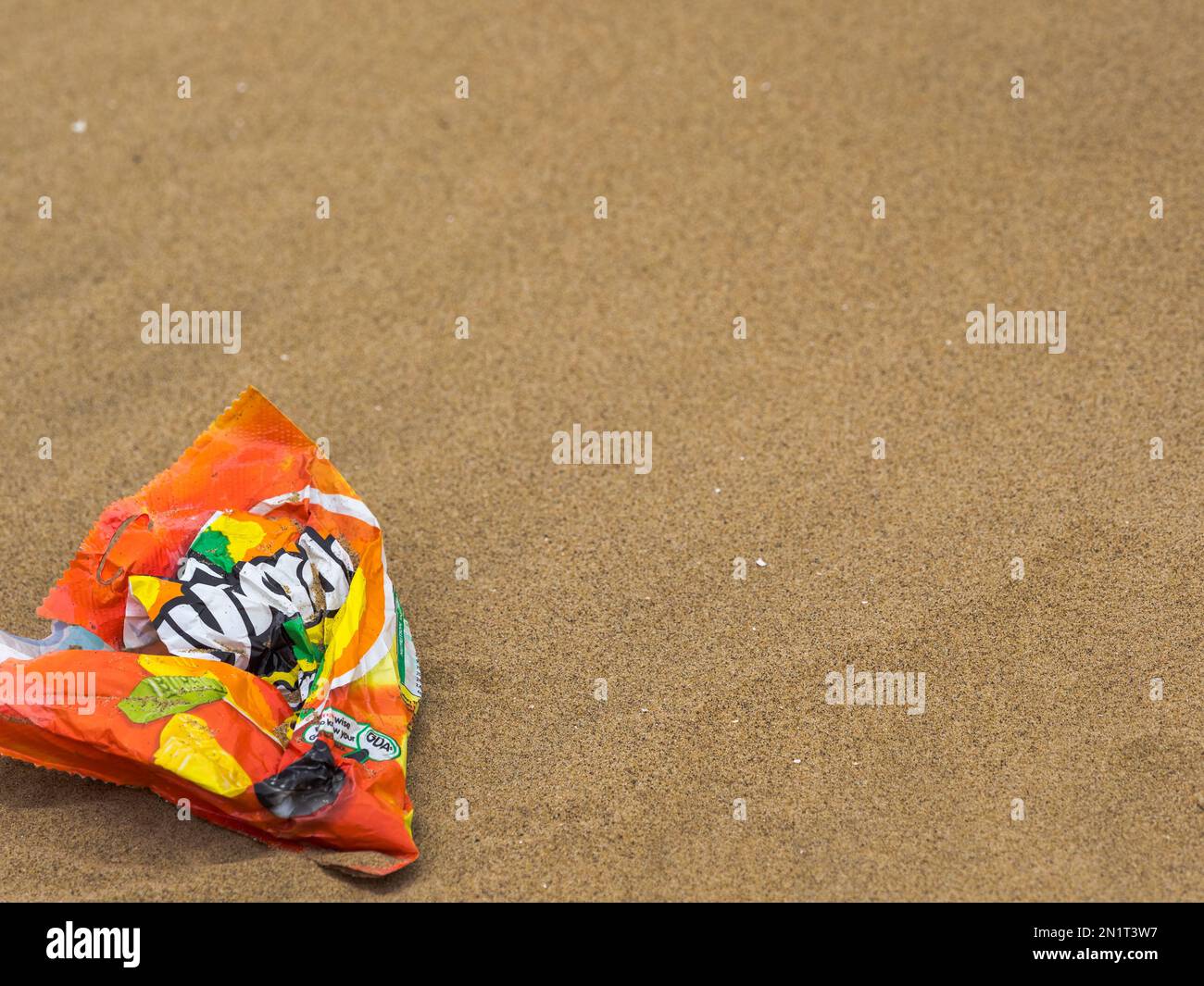 Candy sweet wrappers discarded on the beach copy space for text Stock ...
