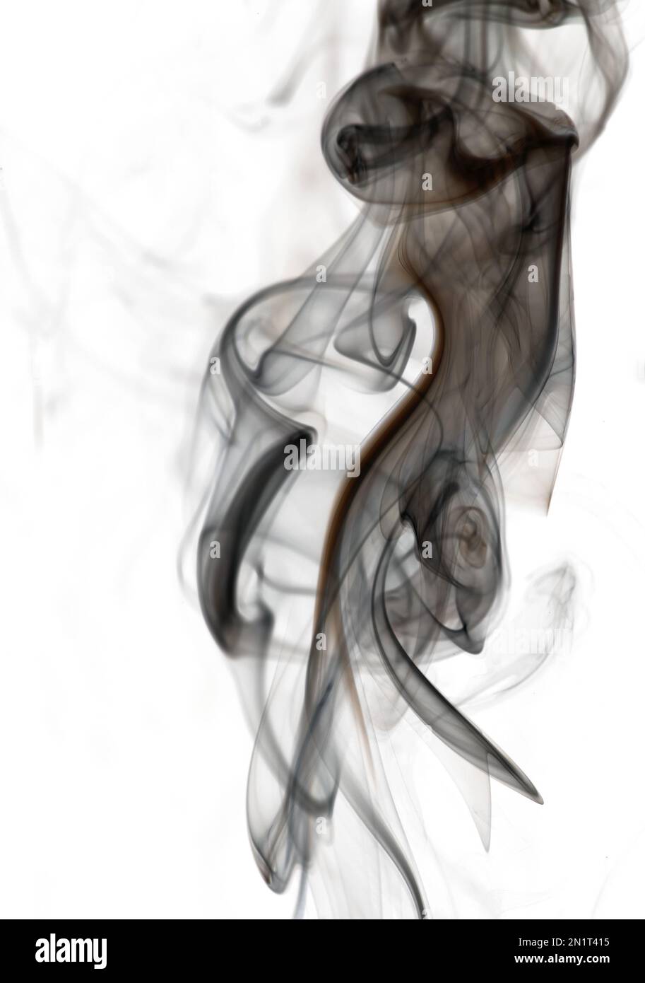 Puffs and curls of dark smoke on a white background rising from a ...
