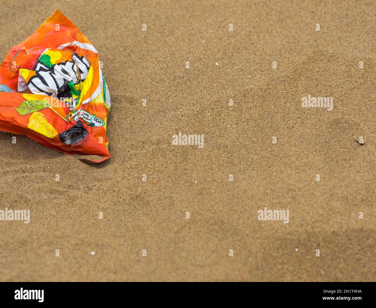 Candy sweet wrappers discarded on the beach copy space for text Stock ...