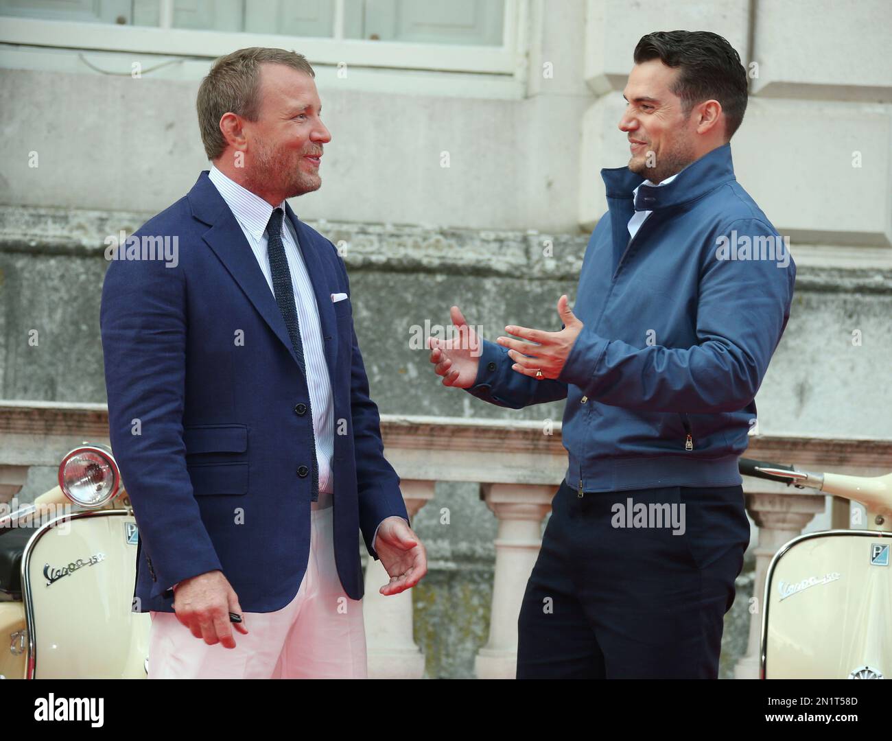 Director Guy Ritchie actor Henry Cavill laugh as they pose for ...