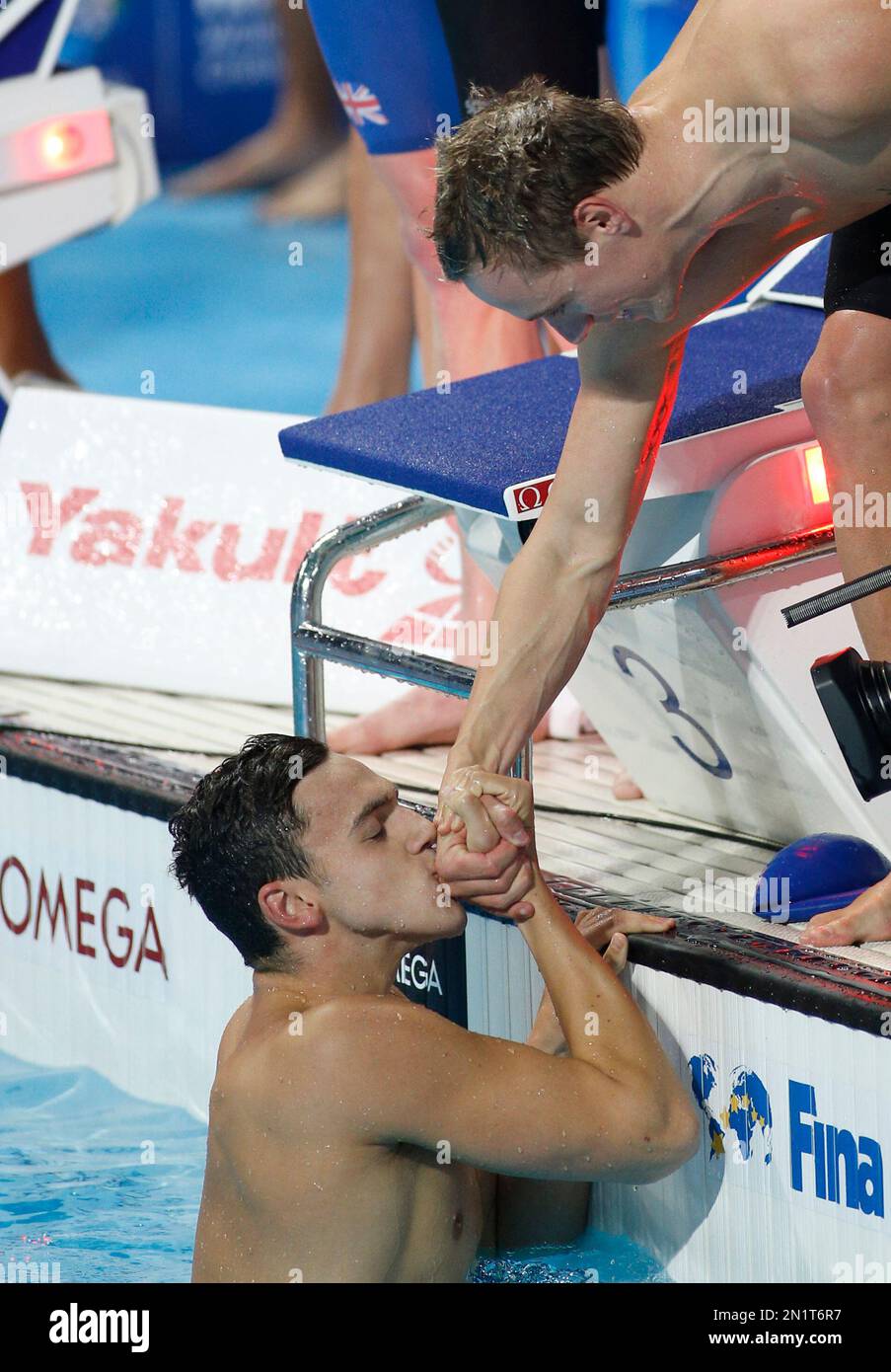 Britain's James Guy kisses the hand of his teammate Robert Peter ...