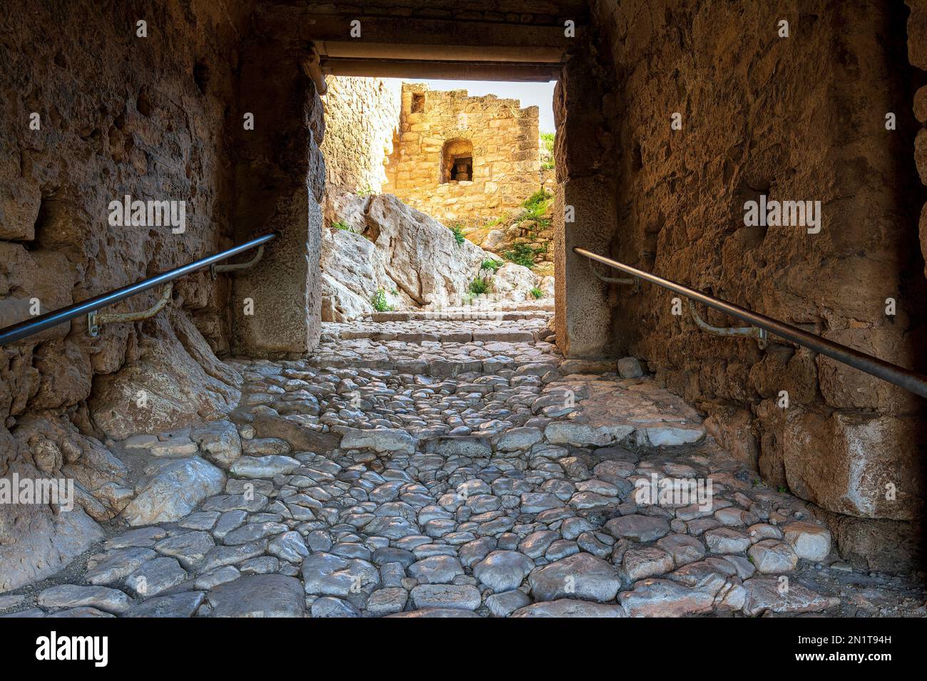 View through a dark stone gate to ruins of the ancient Greek city of ...