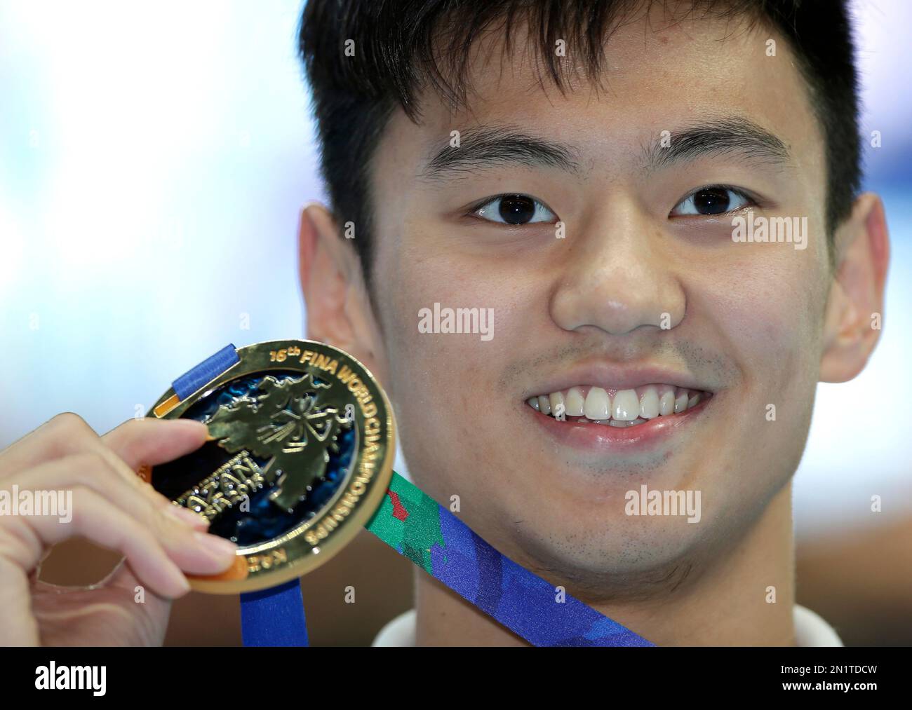 China's Ning Zetao holds his gold medal after winning the men's 100m ...