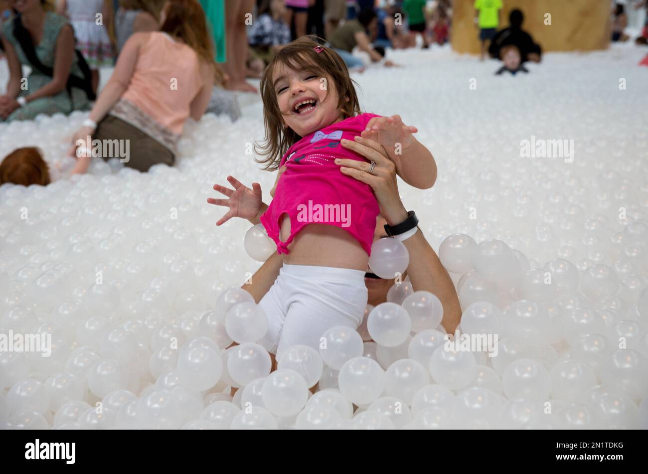 Hailey Beauregard, 2, is lifted by her mother Linda Beauregard, as they ...