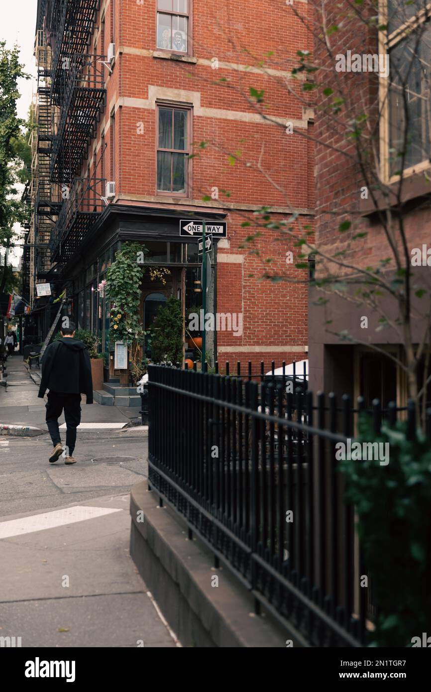 NEW YORK, USA - OCTOBER 11, 2022: Signboard near shop and building on ...