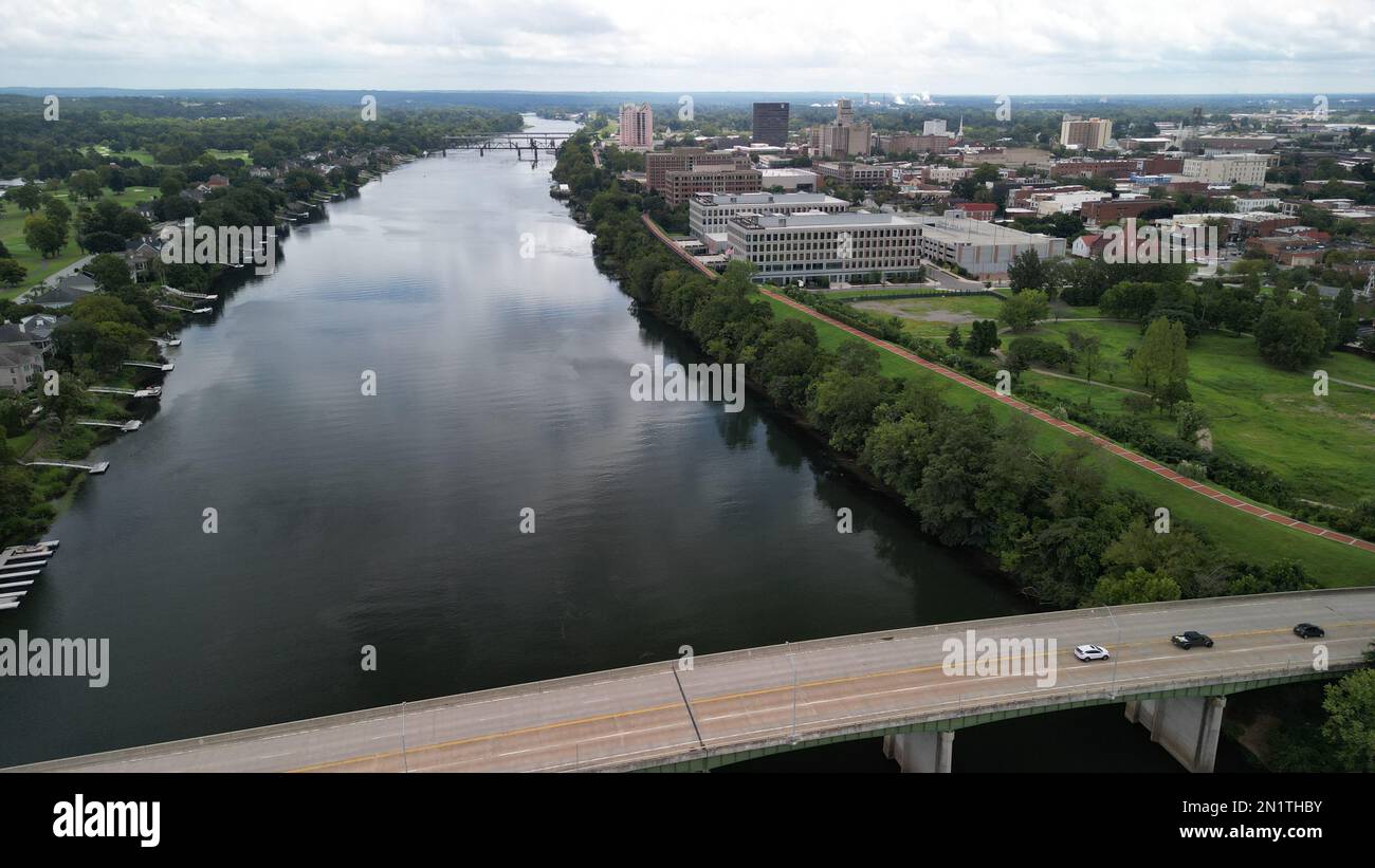 A bird's eye view of a river flowing between residential districts ...