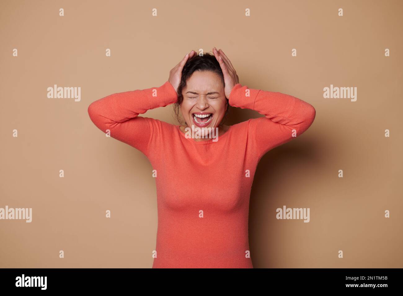 Beautiful multi-ethnic woman with her eyes closed screaming, isolated ...