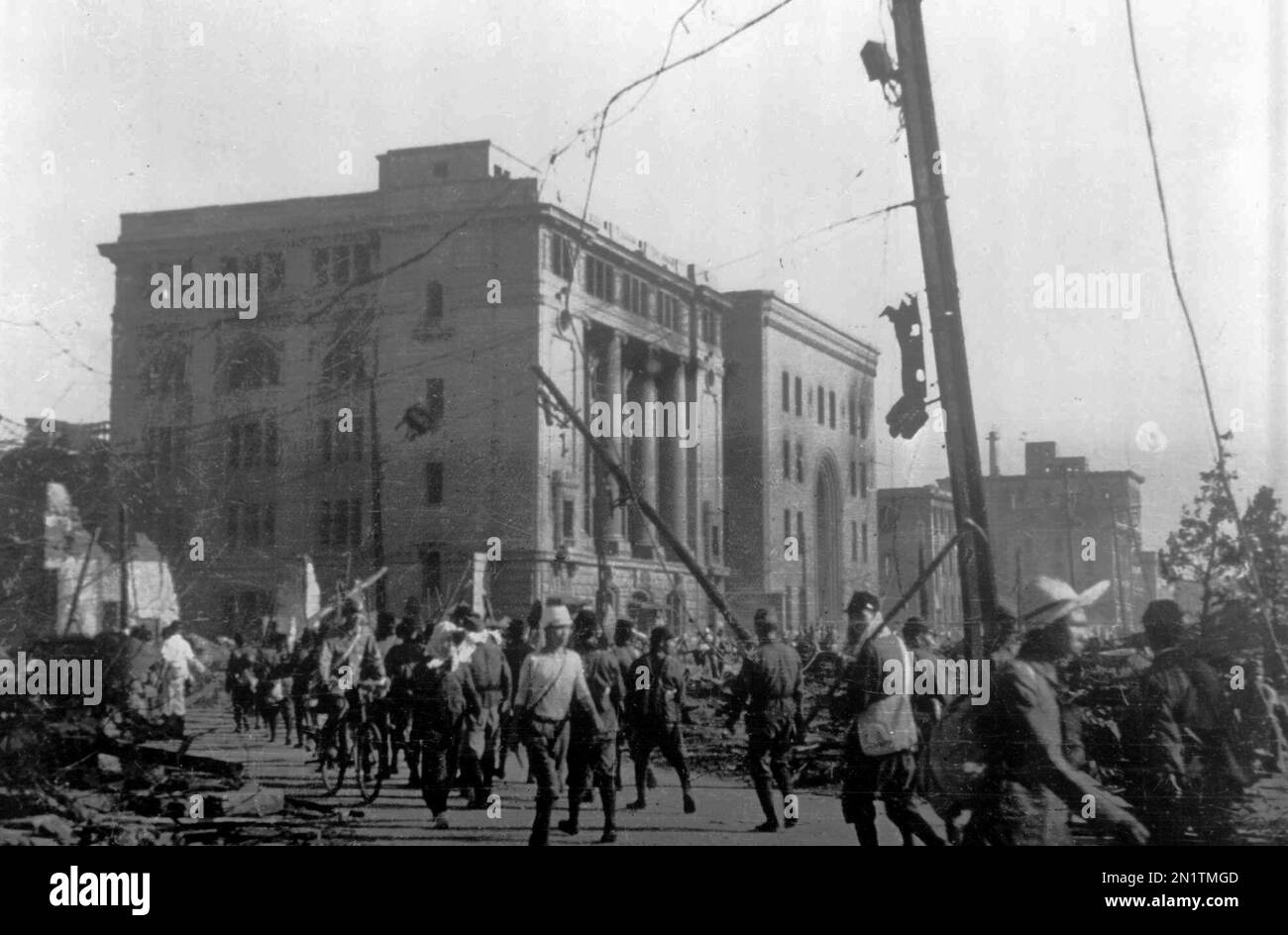 FILE - In this Aug. 8, 1945 file photo, soldiers and civilians walk ...