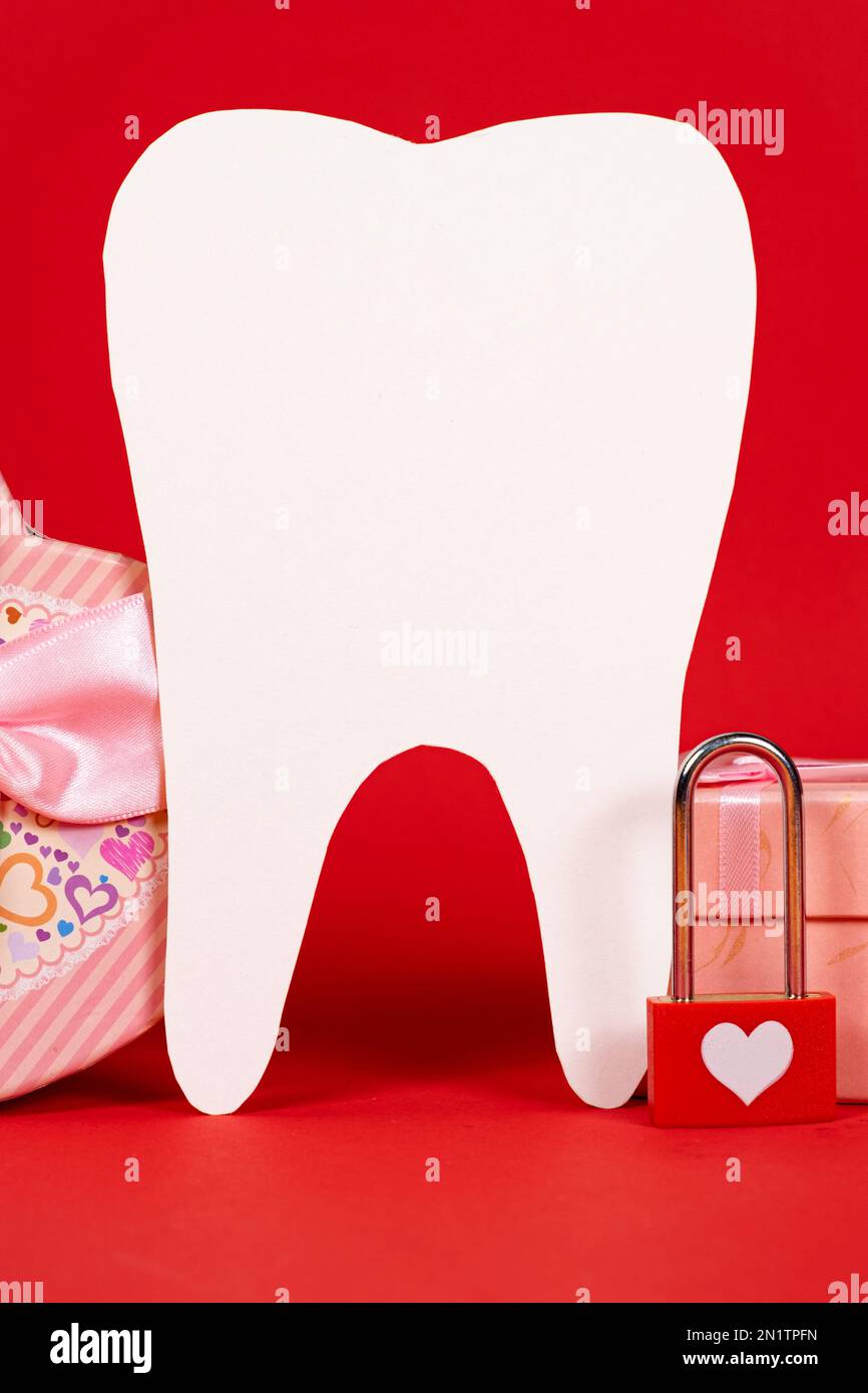 Valentine's Day in dentistry - a large white tooth, a heart and boxes ...