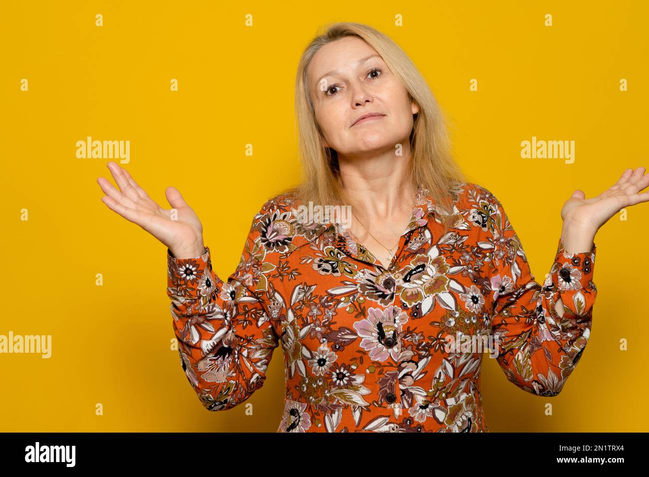 Puzzled woman shrugging confused, hands in the air. Caucasian model ...