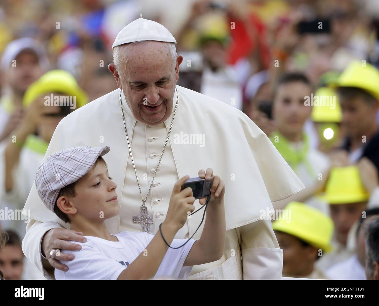 Pope Francis is showed his portrait taken by a boy as he arrives in St ...