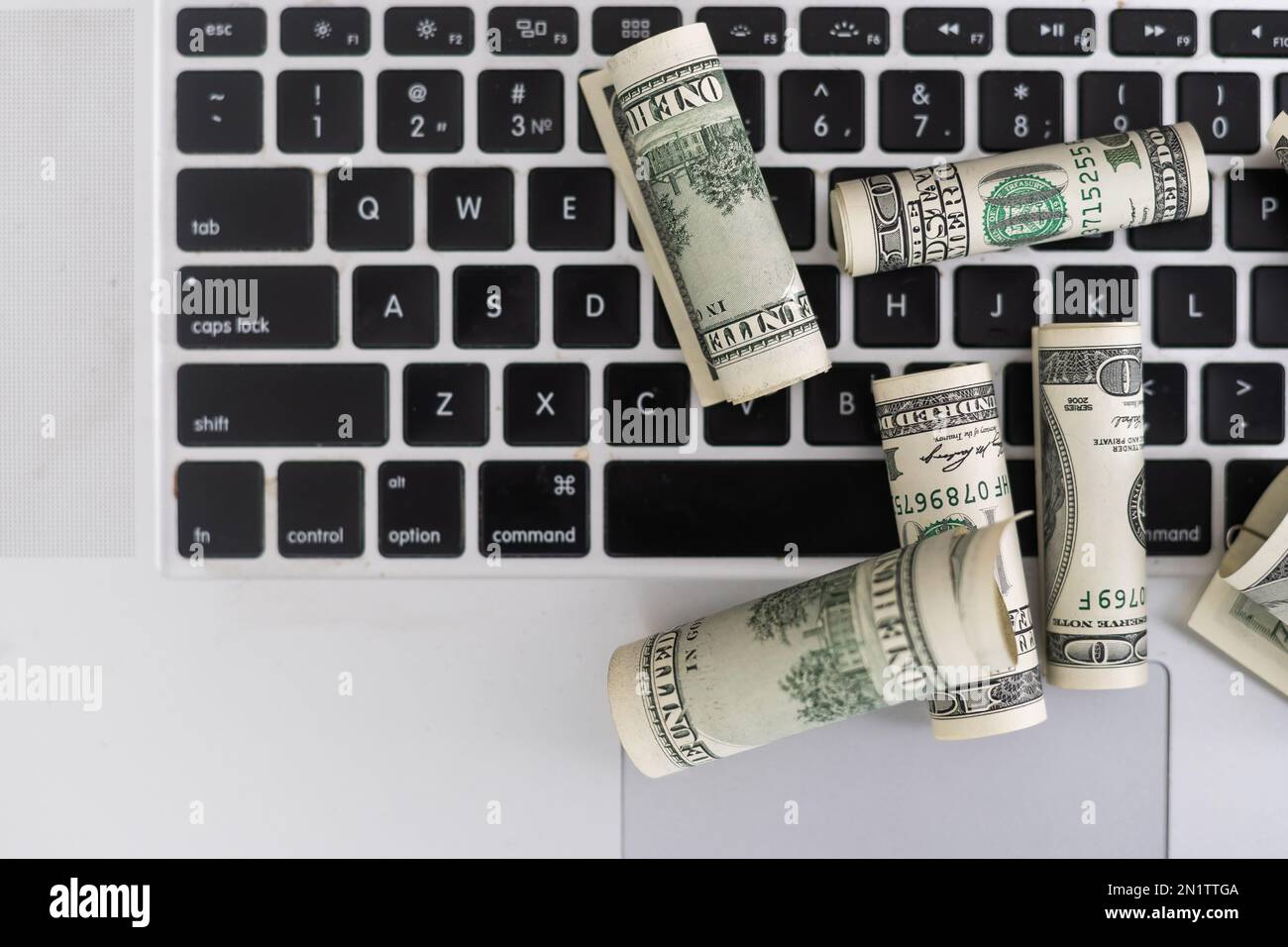 Money on computer keyboard. roll Stock Photo - Alamy