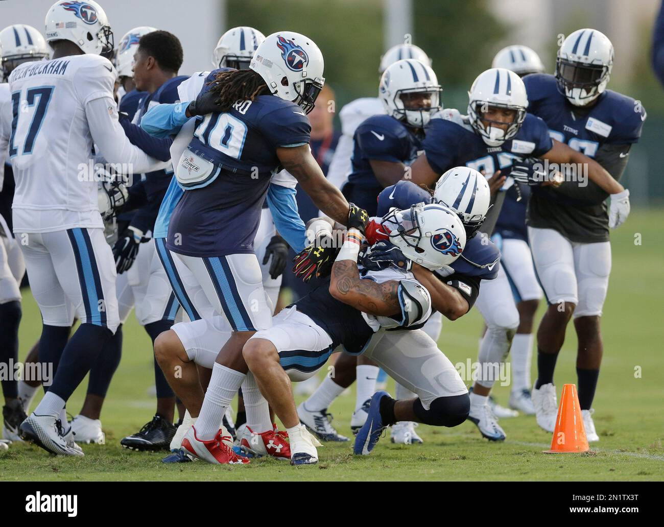 Tennessee Titans wide receiver Deon Long, bottom center, is pulled down ...