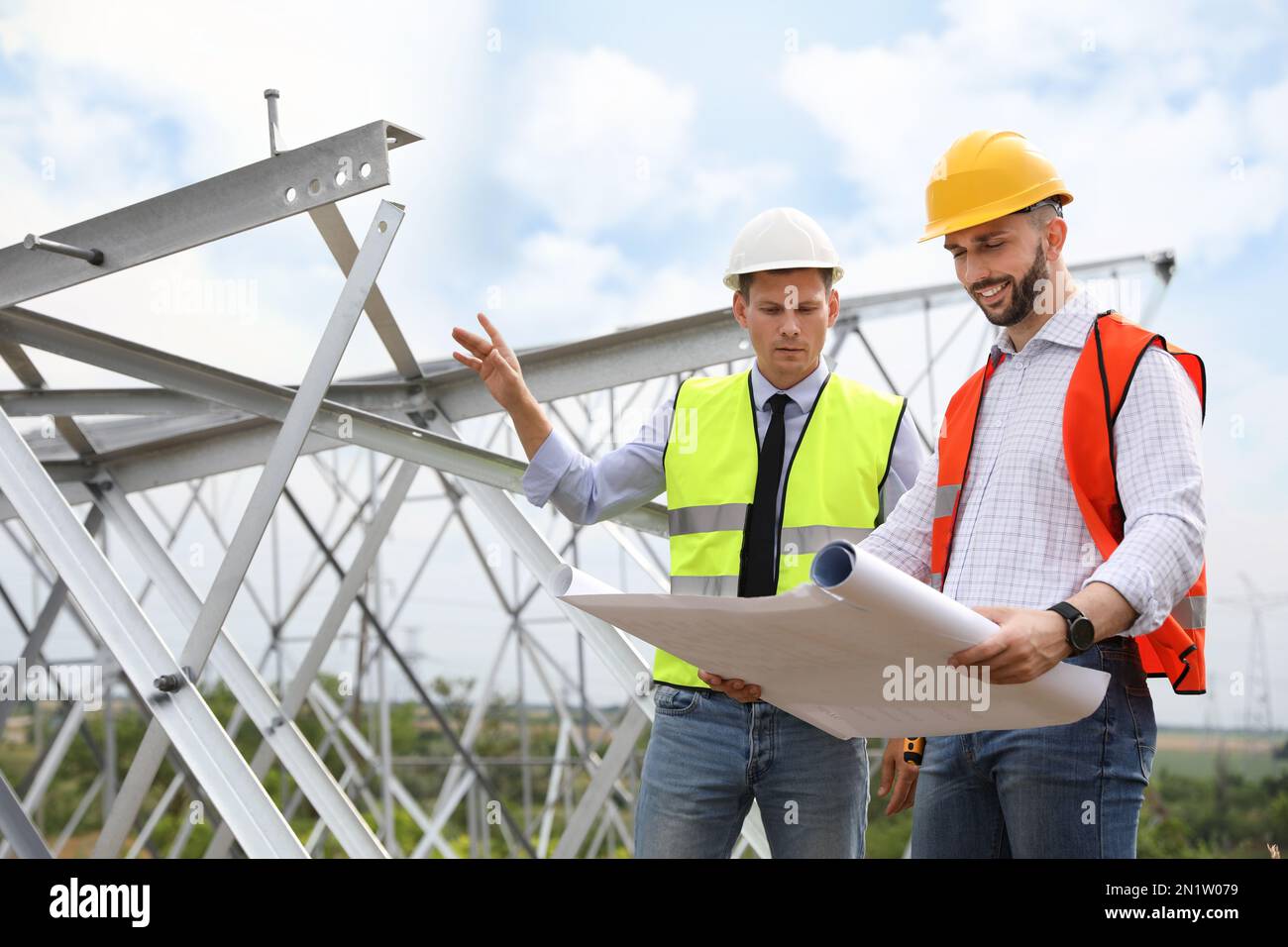 Professional engineers working on installation of electrical substation ...