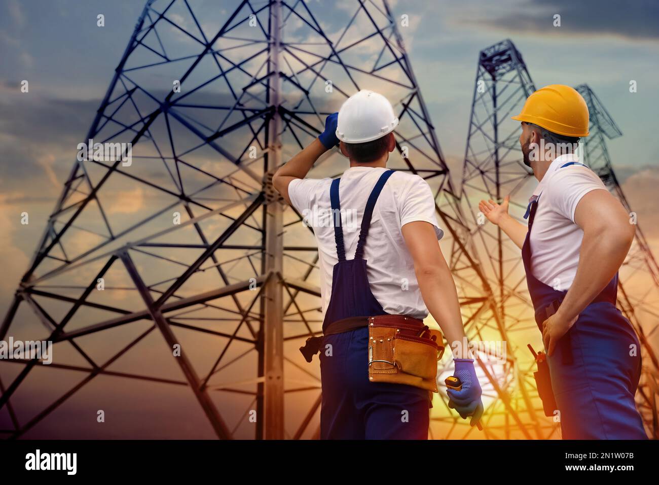 Professional engineers working on installation of electrical substation ...