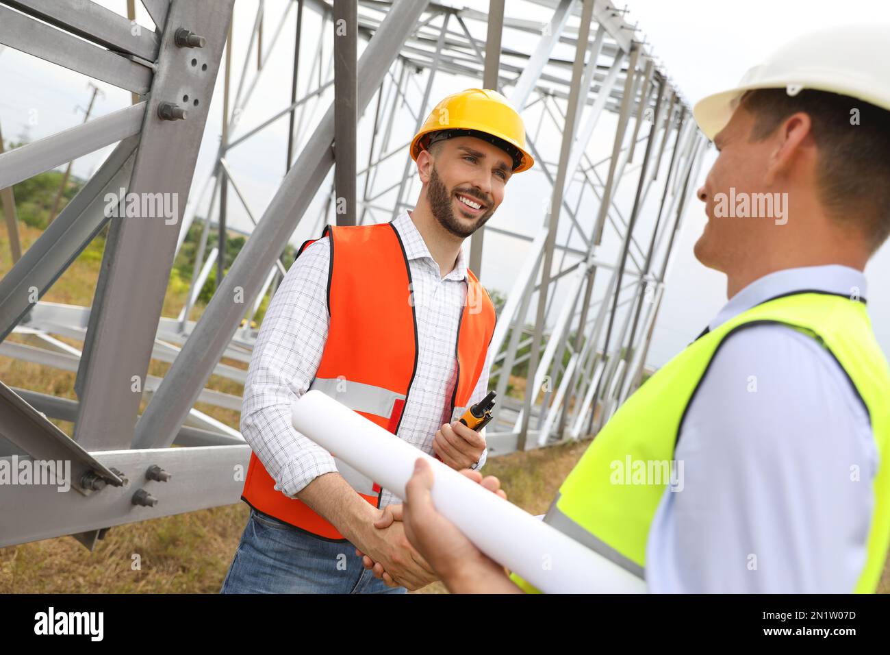 Professional engineers working on installation of electrical substation ...
