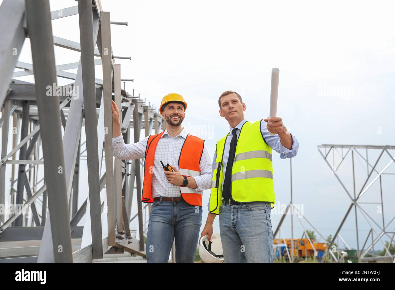Professional engineers working on installation of electrical substation ...