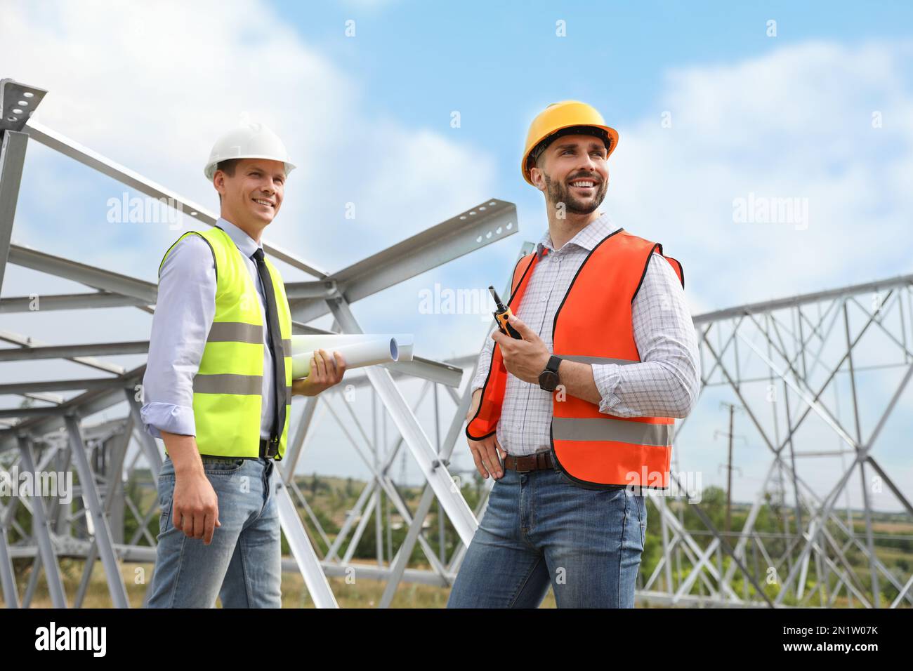 Professional engineers working on installation of electrical substation ...