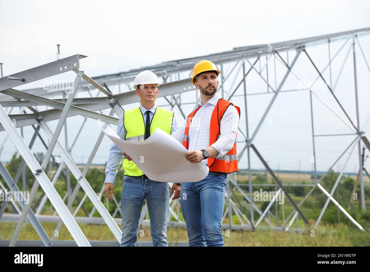 Professional engineers working on installation of electrical substation ...